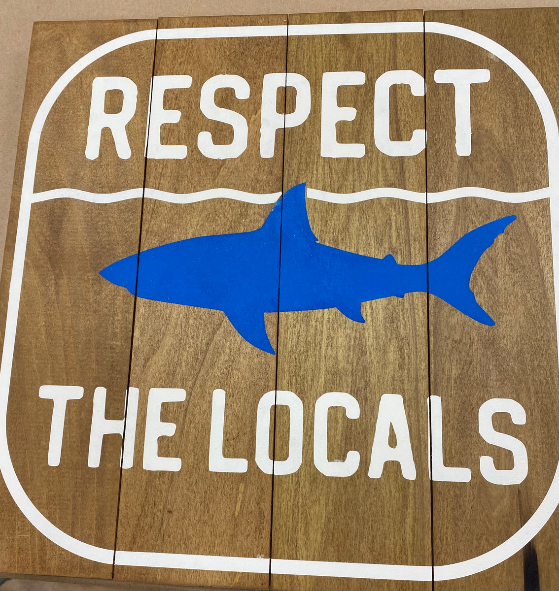 Respect the locals sign – Words on Wood